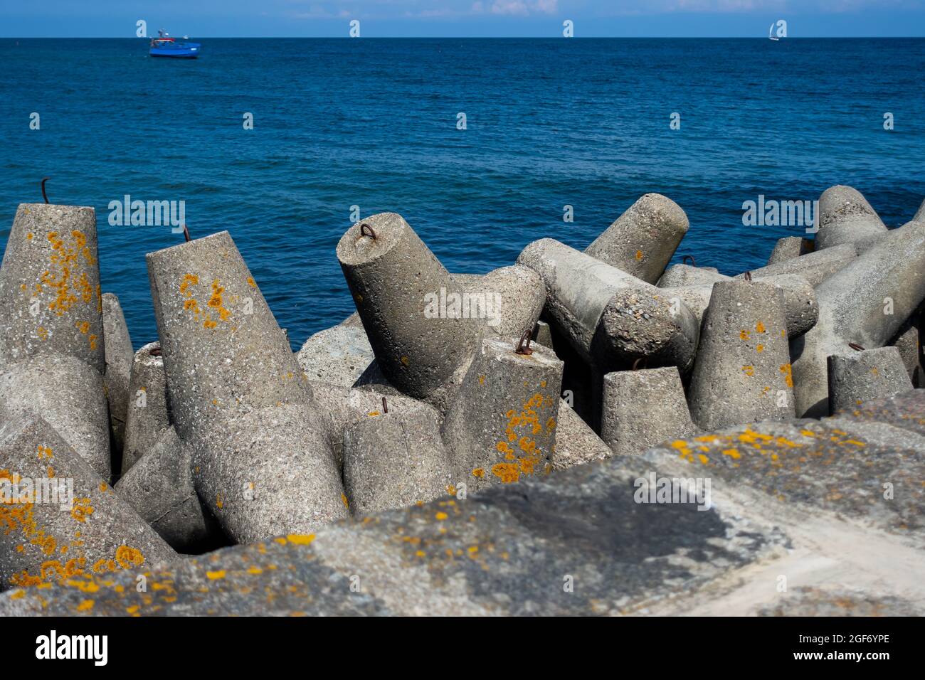 Concrete breakwater at the entrance to the port. Photo taken in the ...