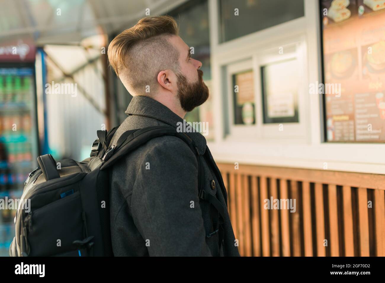 Portrait of man choosing fast food in food truck in the street. Meal ...