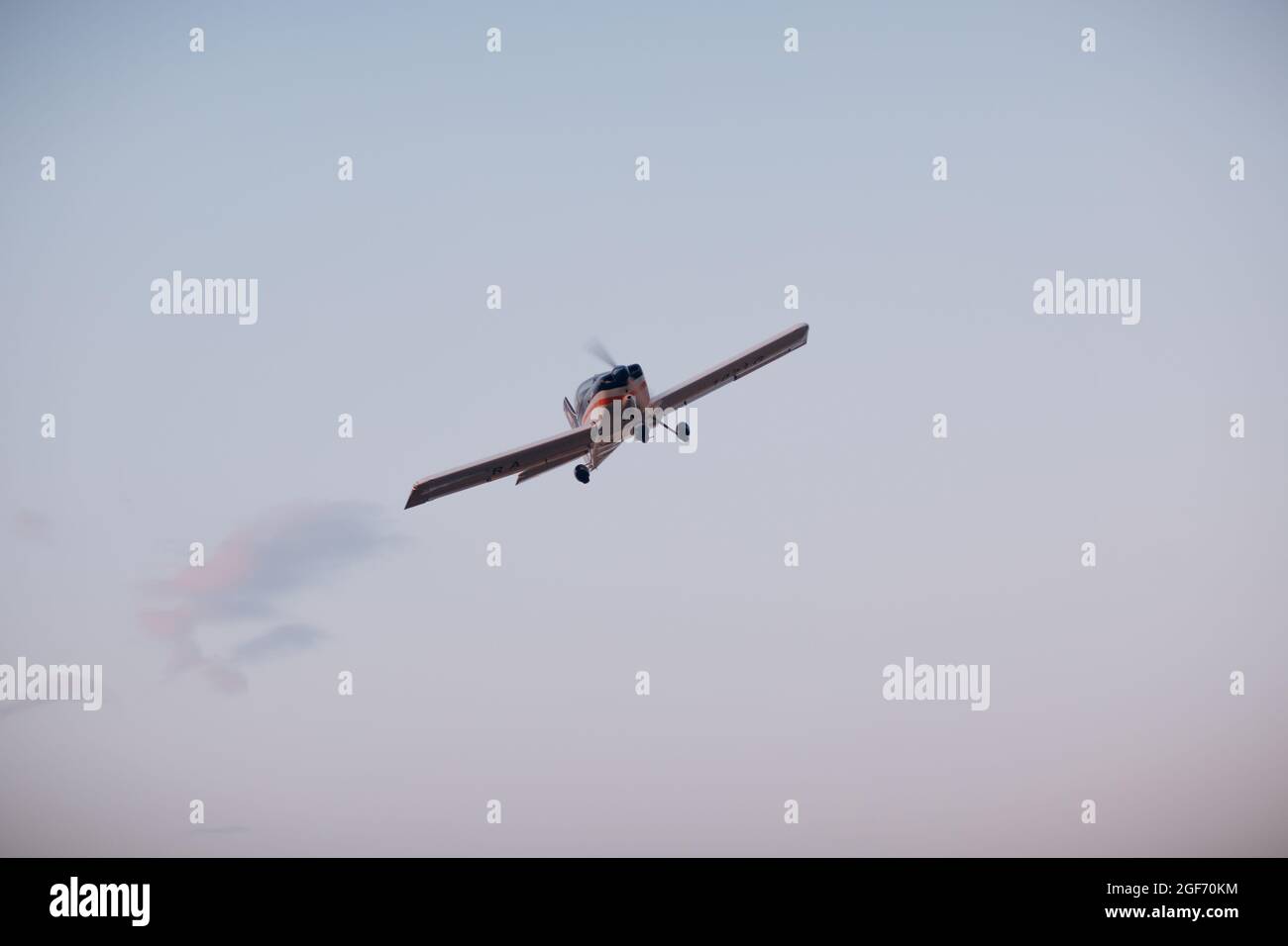 Small single engine airplane flying against sunset sky Stock Photo - Alamy