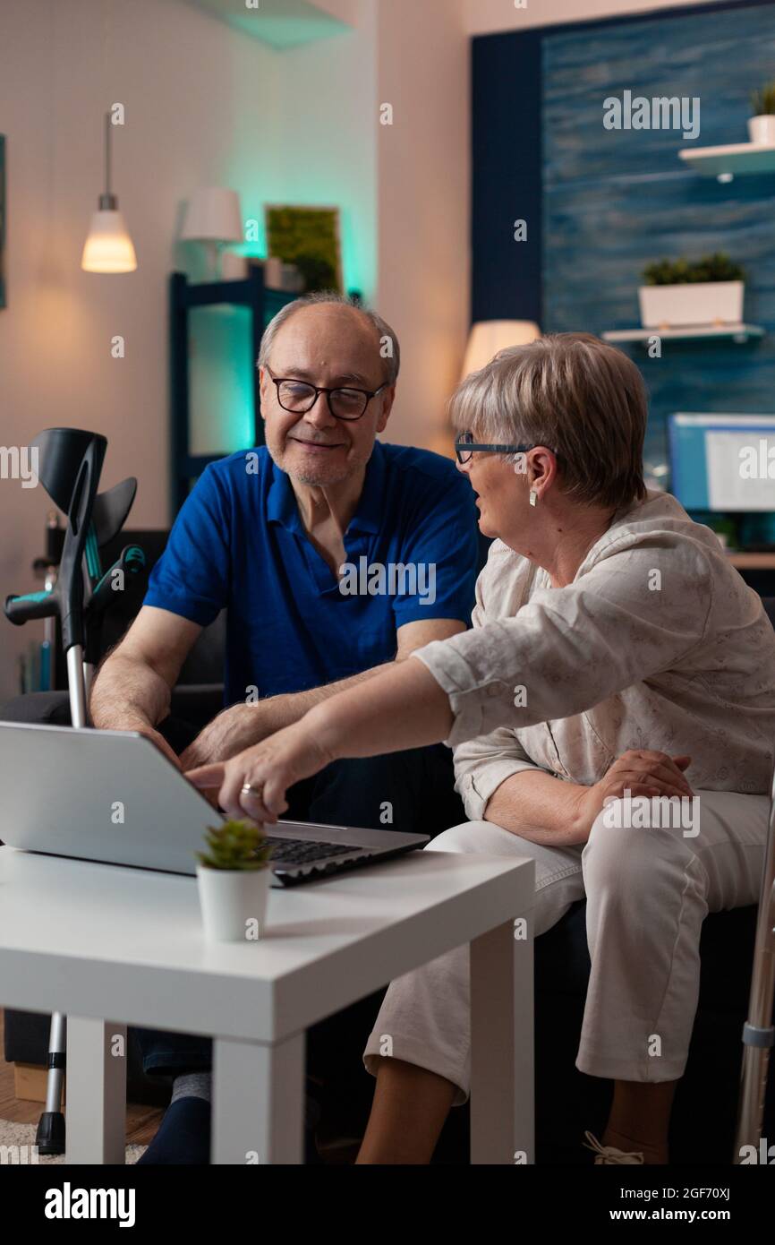 Gray haired woman old man analyzing laptop screen computer monitor at ...