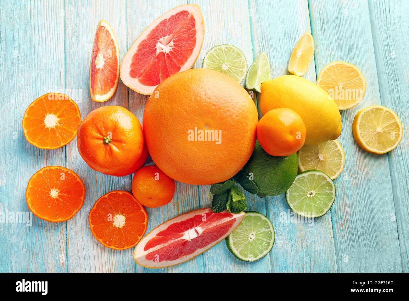 Juicy composition of tropical fruits on wooden background Stock Photo ...