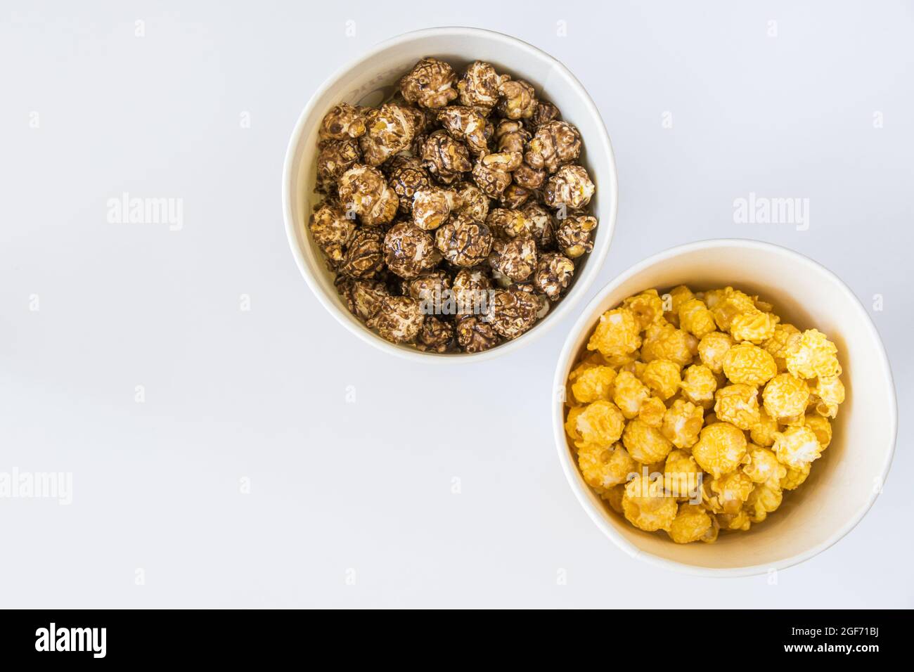Top view of sweet popcorn in bowls on a white background Stock Photo ...