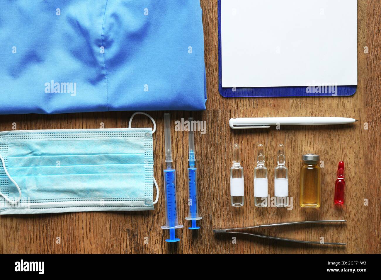 Doctor table with medicines and uniform, top view Stock Photo - Alamy