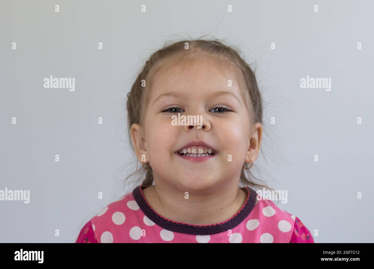 Portrait of smiling caucasian child of three years old looking at ...