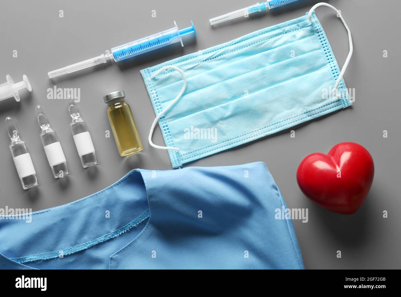 Doctor table with medicines and uniform, top view Stock Photo - Alamy