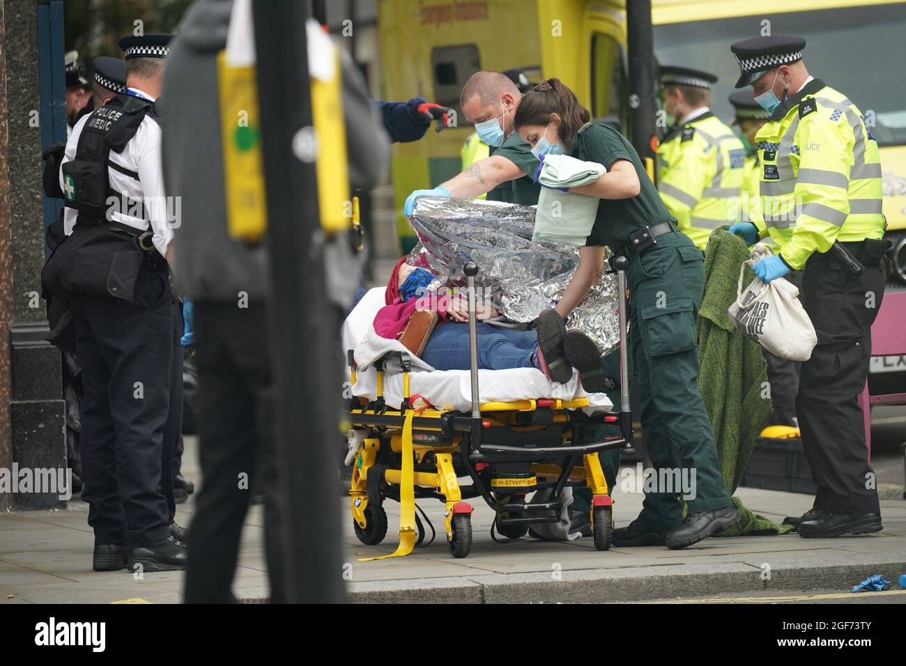 A female protester on a stretcher is attended to by paramedics from the ...