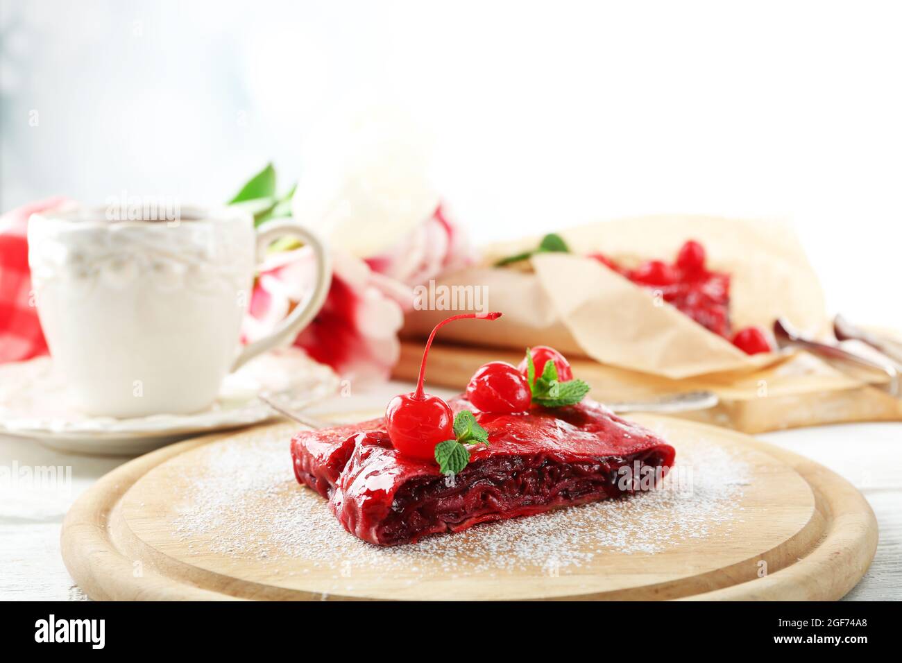 Cherry strudel with mint and cup of tea Stock Photo - Alamy
