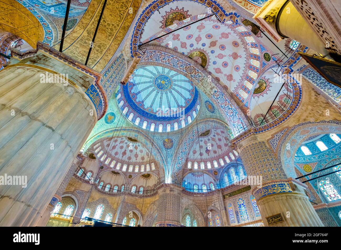 Looking up at the blue tiled columns and dome. Inside the Sultan Ahmed ...