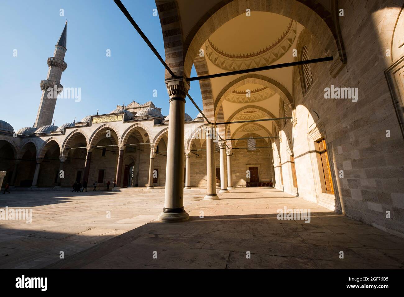 In the courtyard, arched and domed portico and a minaret. At the big ...