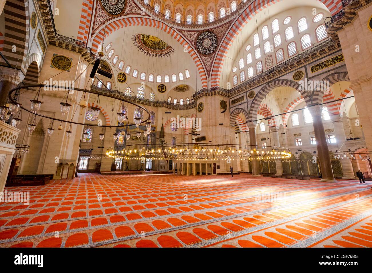 Inside, the main prayer area with low chandelier and dome. At the big ...