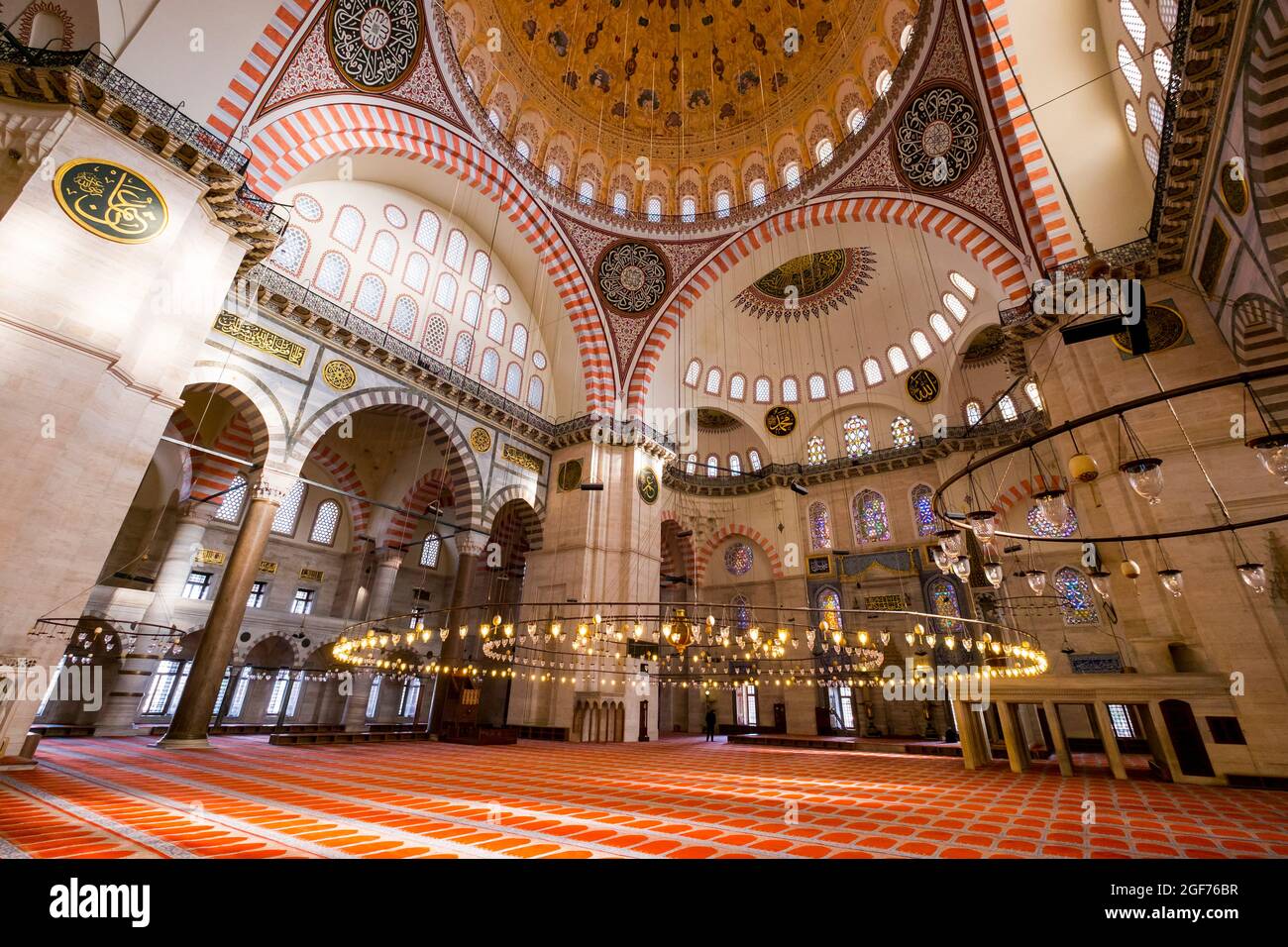 Inside, the main prayer area with low chandelier and dome. At the big ...