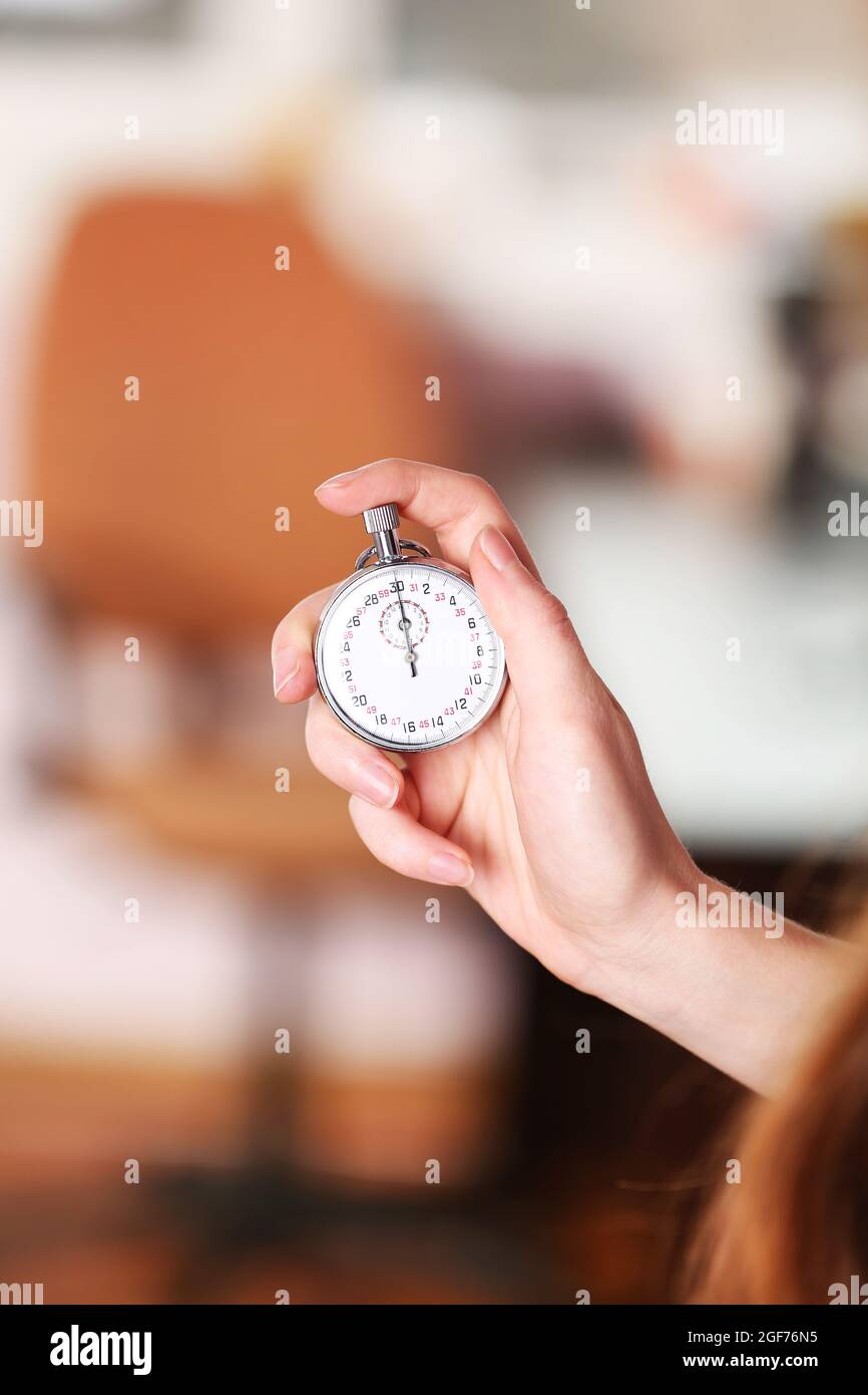 Woman holds stopwatch in hand, close up Stock Photo - Alamy