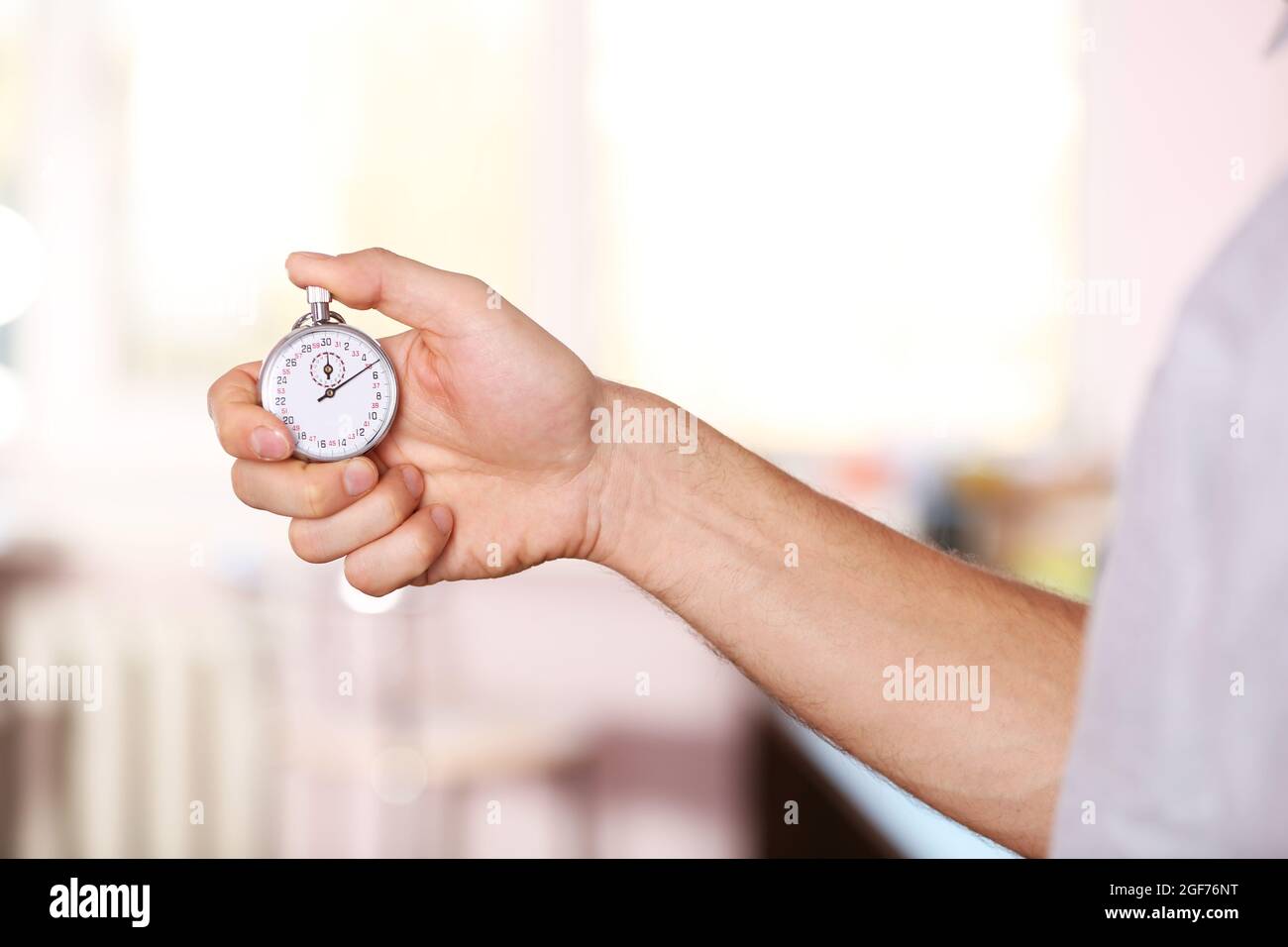 Man holds stopwatch in hand, close up Stock Photo - Alamy