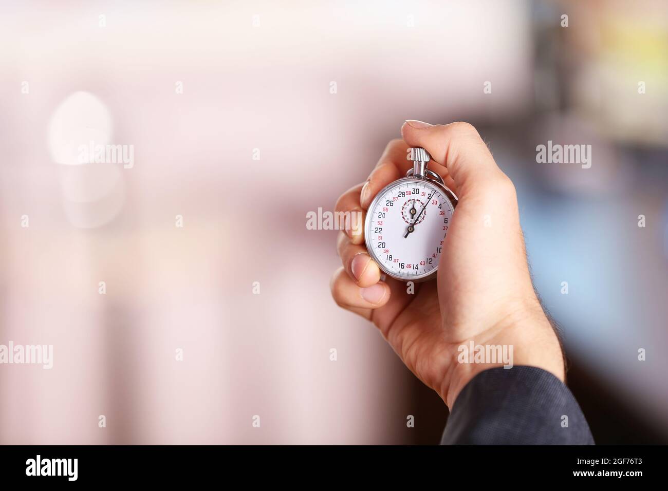 Man holds stopwatch in hand, close up Stock Photo - Alamy