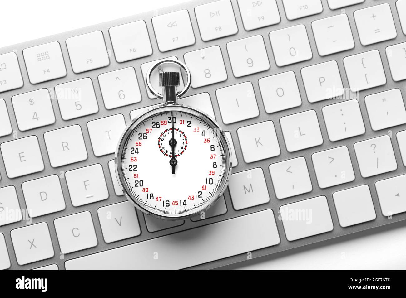 Stopwatch on white keyboard background, close up Stock Photo - Alamy