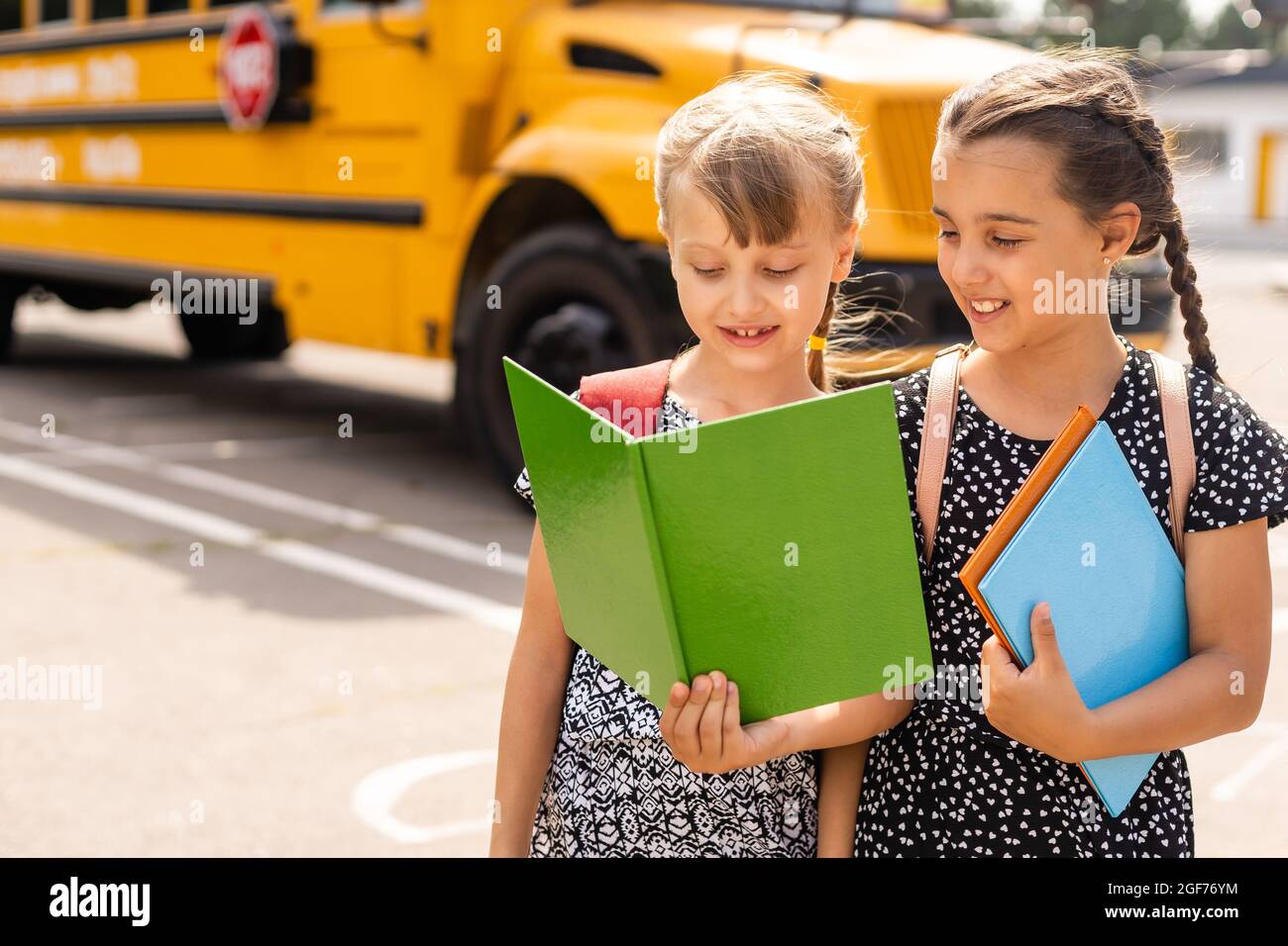 Portrait of two girls with school bags after lesson in school Stock ...