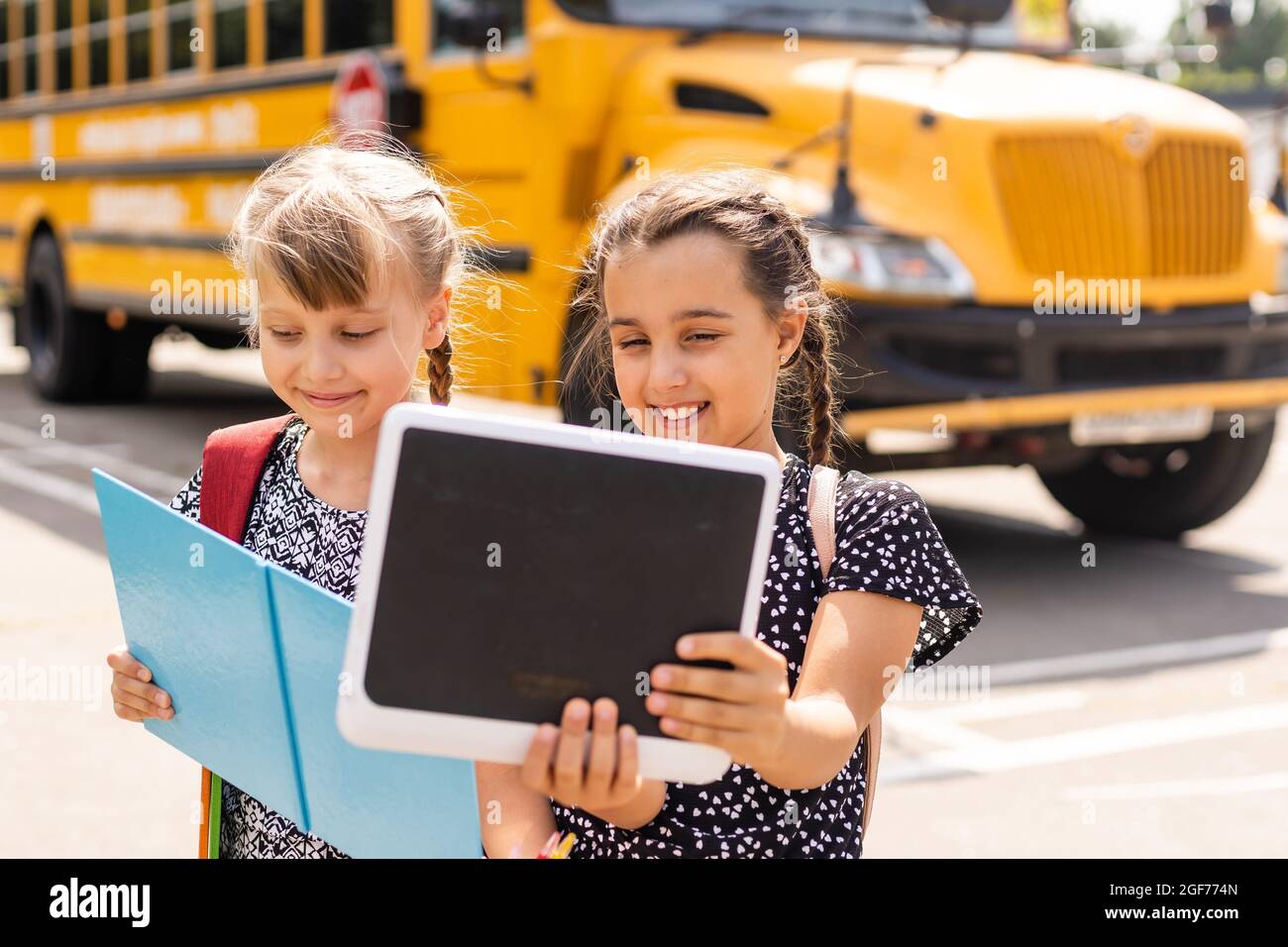 Two little kids going to school together Stock Photo - Alamy