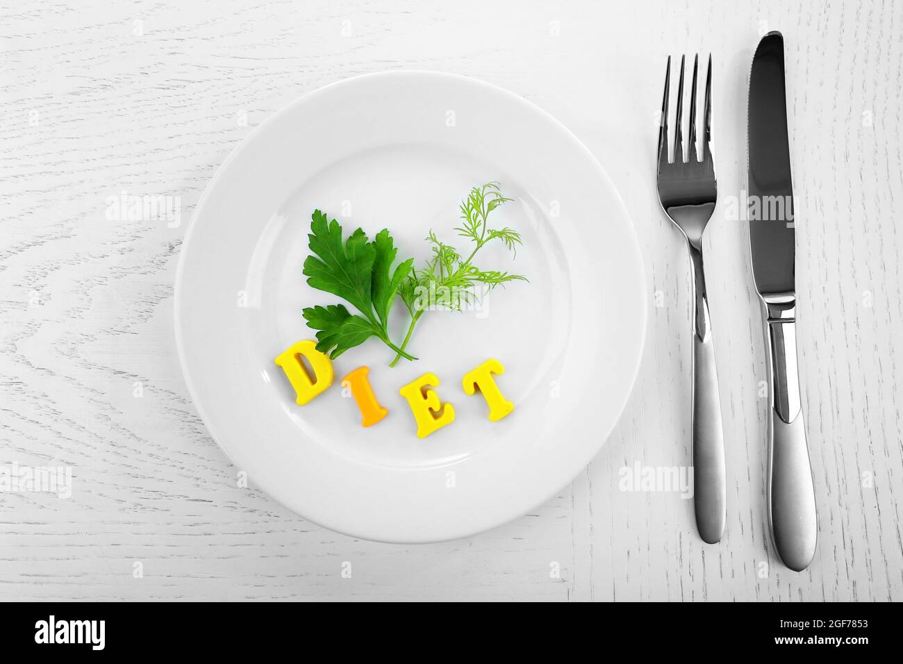 Word DIET with greens in plate on wooden table, top view Stock Photo ...