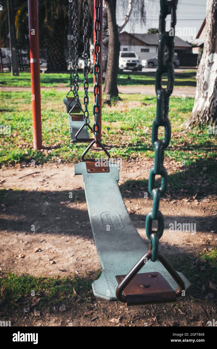 Empty chain swings on the playground Stock Photo - Alamy