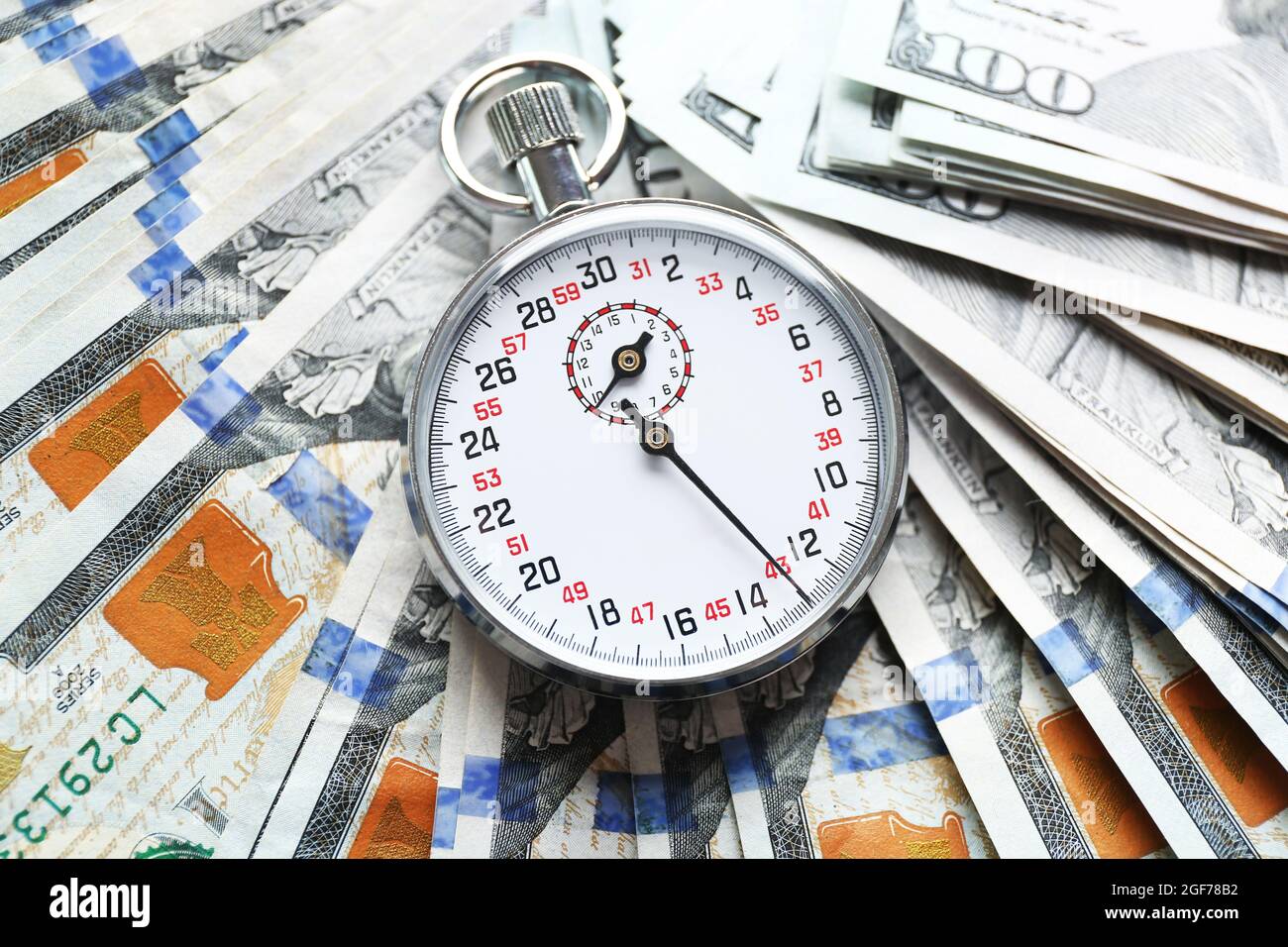 Stopwatch on dollar banknotes. Time is money concept Stock Photo - Alamy