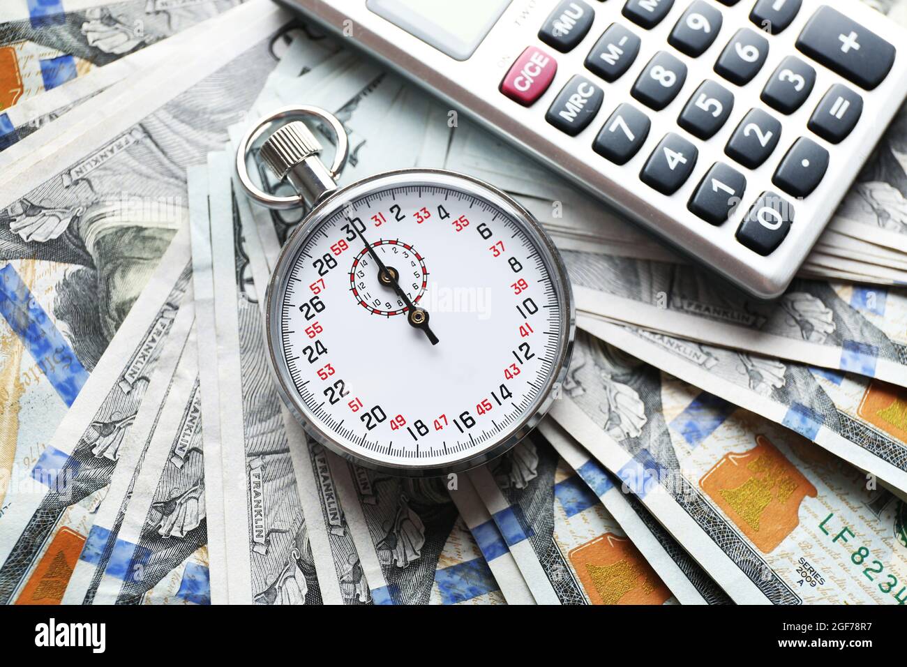 Stopwatch with calculator on dollar banknotes. Time is concept Stock ...