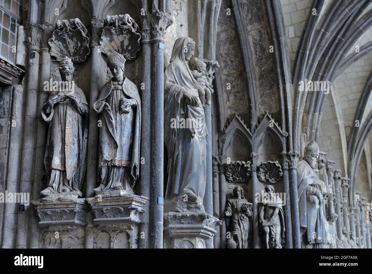 Old sculptures in need of renovation at the entrance gate to Notre-Dame ...