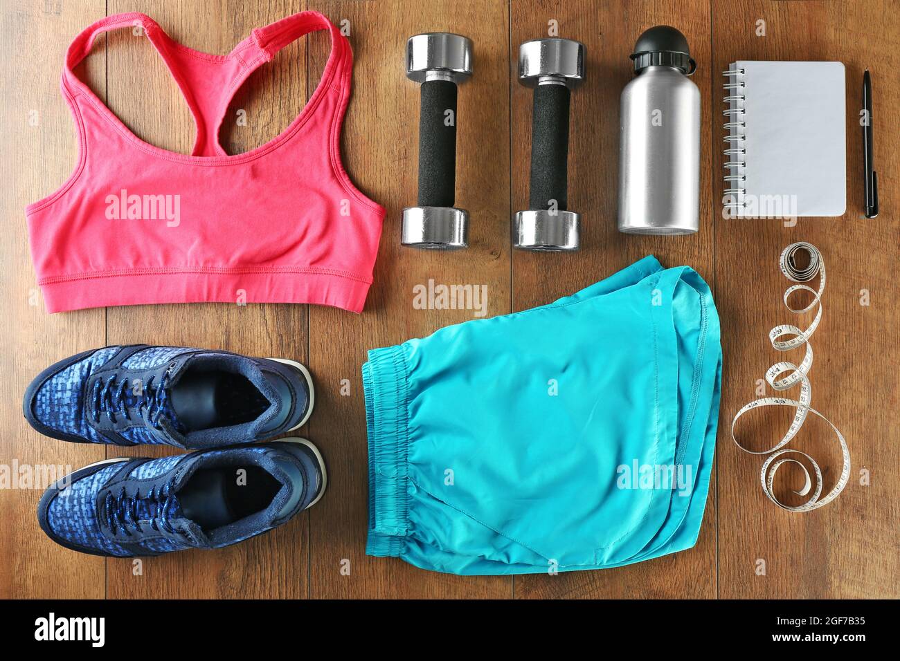 Athlete's set with female clothing, equipment, bottle of water and ...