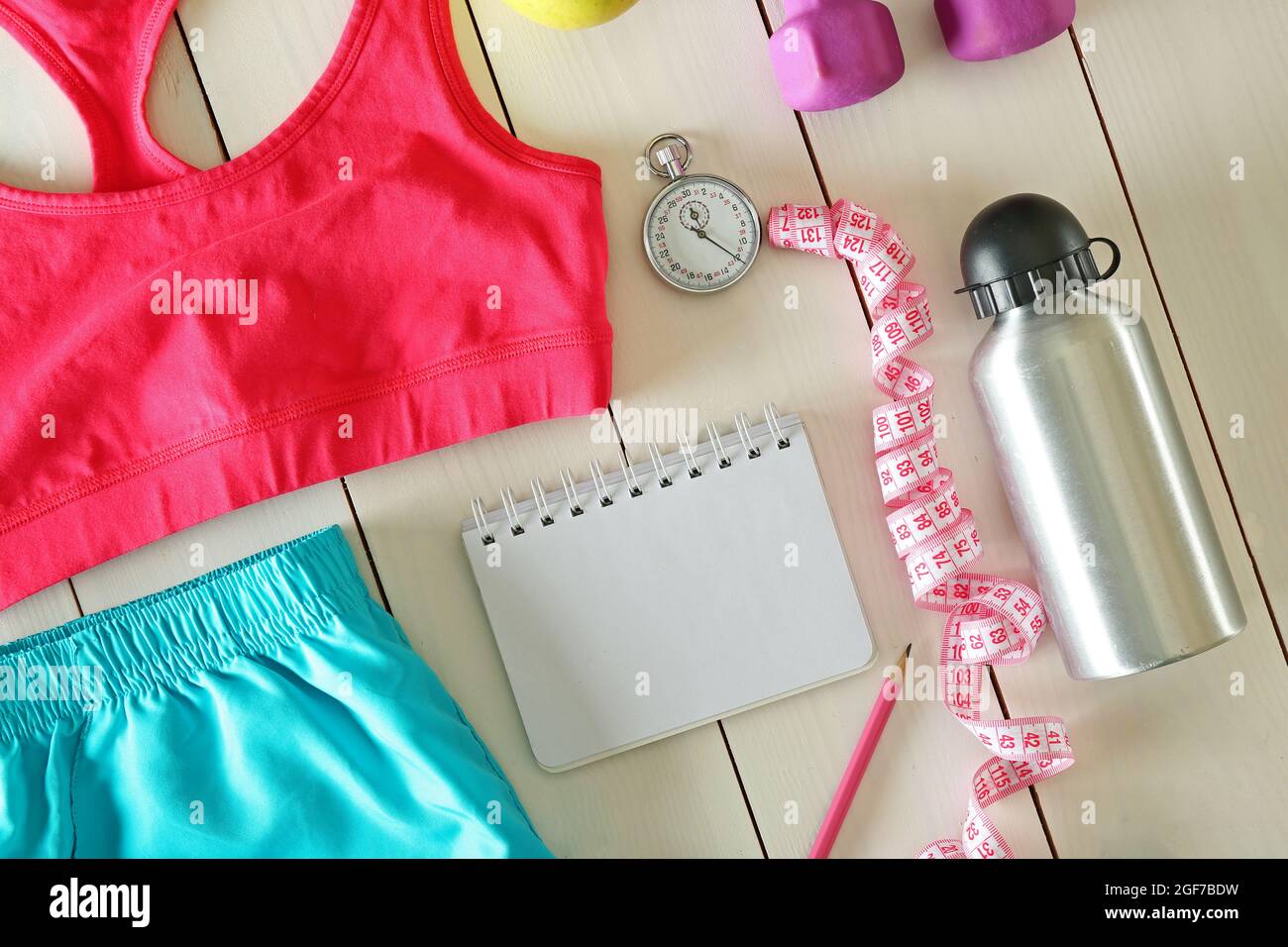 Athlete's set with female clothing, equipment, bottle of water and ...
