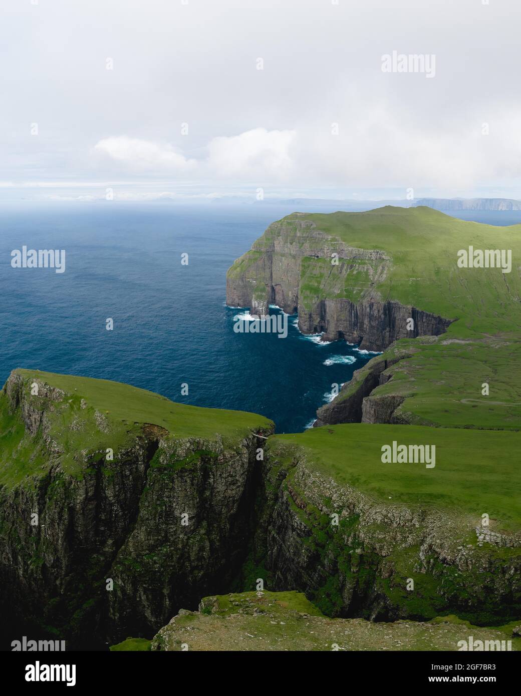 Aerial view, Asmundarstakkur cliff, Sandvik, Suduroy, Faroe Islands ...