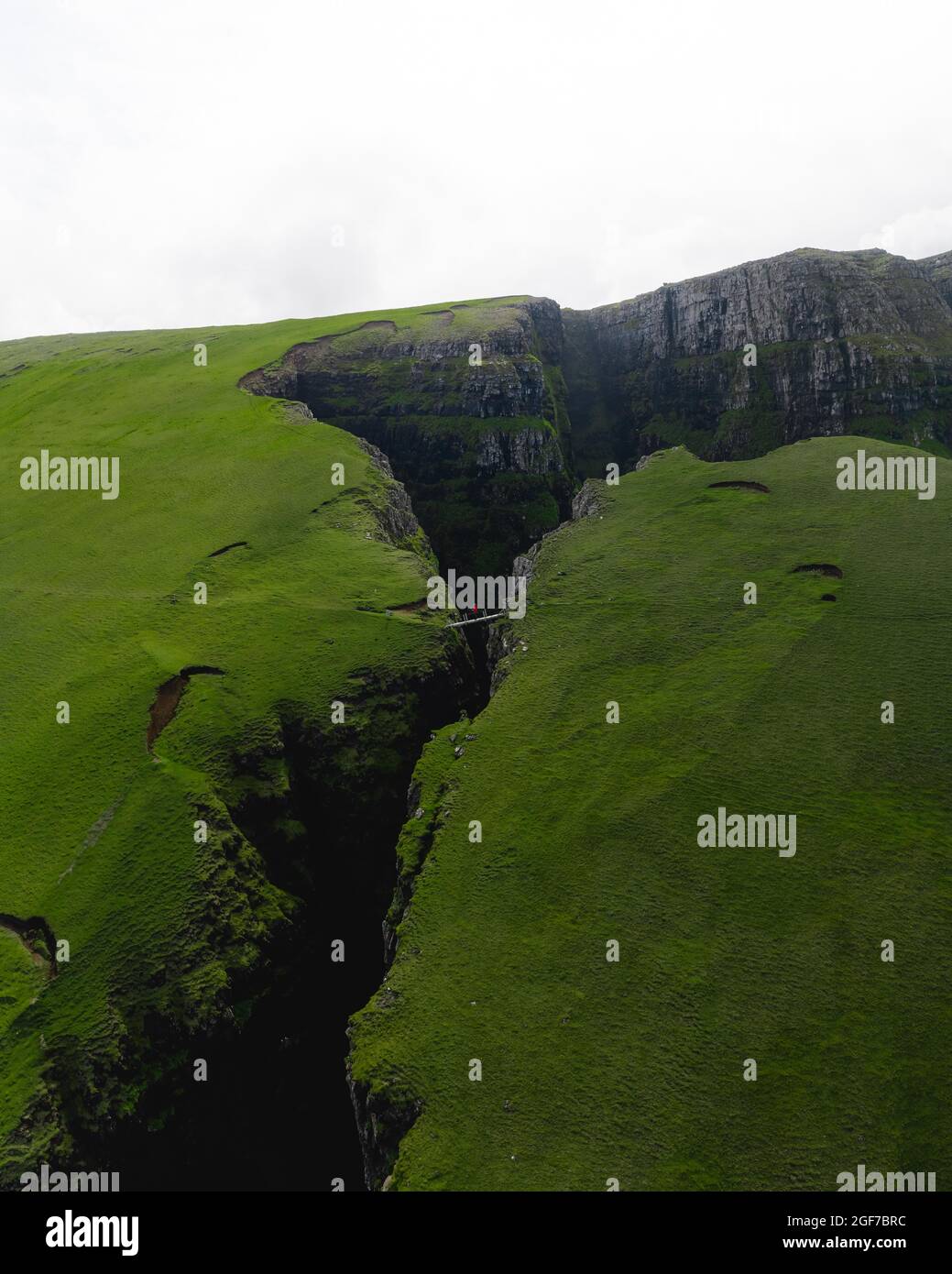 Aerial view, Asmundarstakkur cliff with small wooden bridge, Sandvik ...