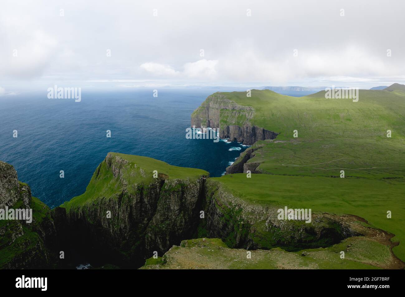 Aerial view, Asmundarstakkur cliff, Sandvik, Suduroy, Faroe Islands ...