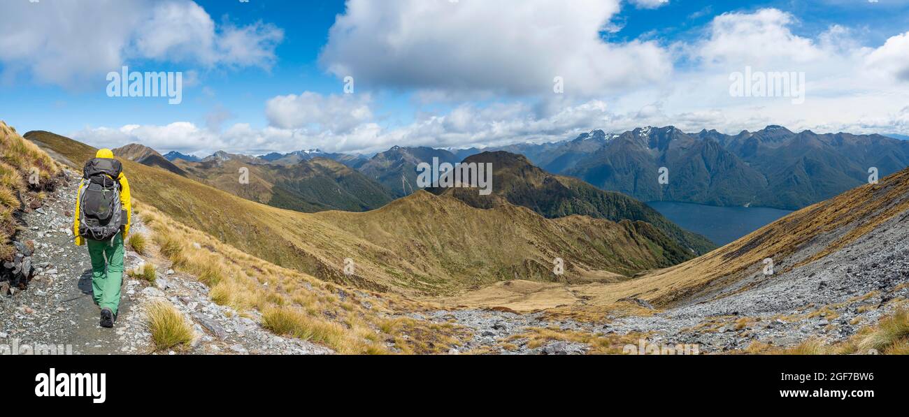 Hikers on trail, view of mountain peaks of Murchison Mountains and ...