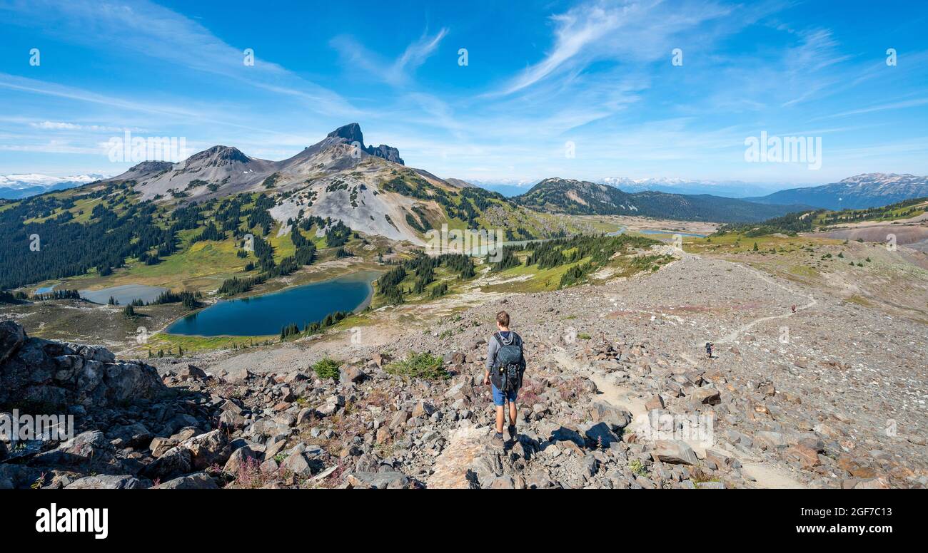 Hikers on trail to Panorama Ridge, Blue Lakes in front of volcanic ...