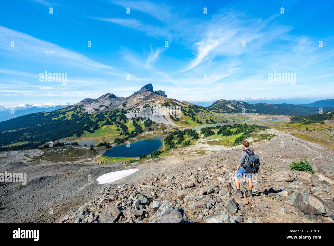 Hikers on trail to Panorama Ridge, Blue Lakes in front of volcanic ...
