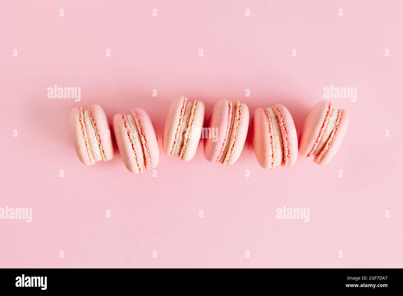 Tasty french macarons on a pink pastel background. Place for text Stock ...