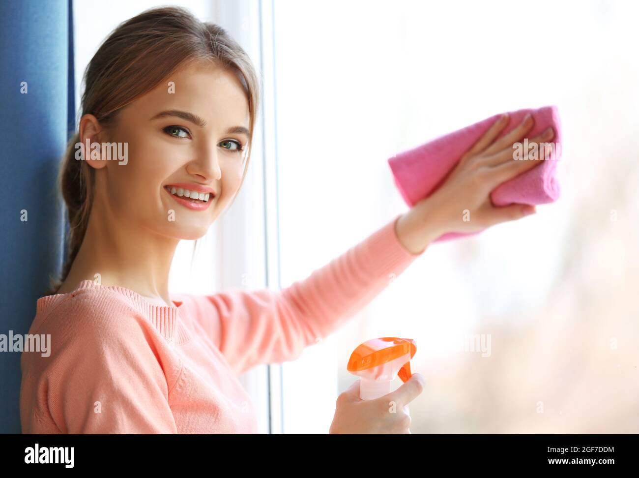 Cleaning concept. Young woman washing window, close up Stock Photo - Alamy