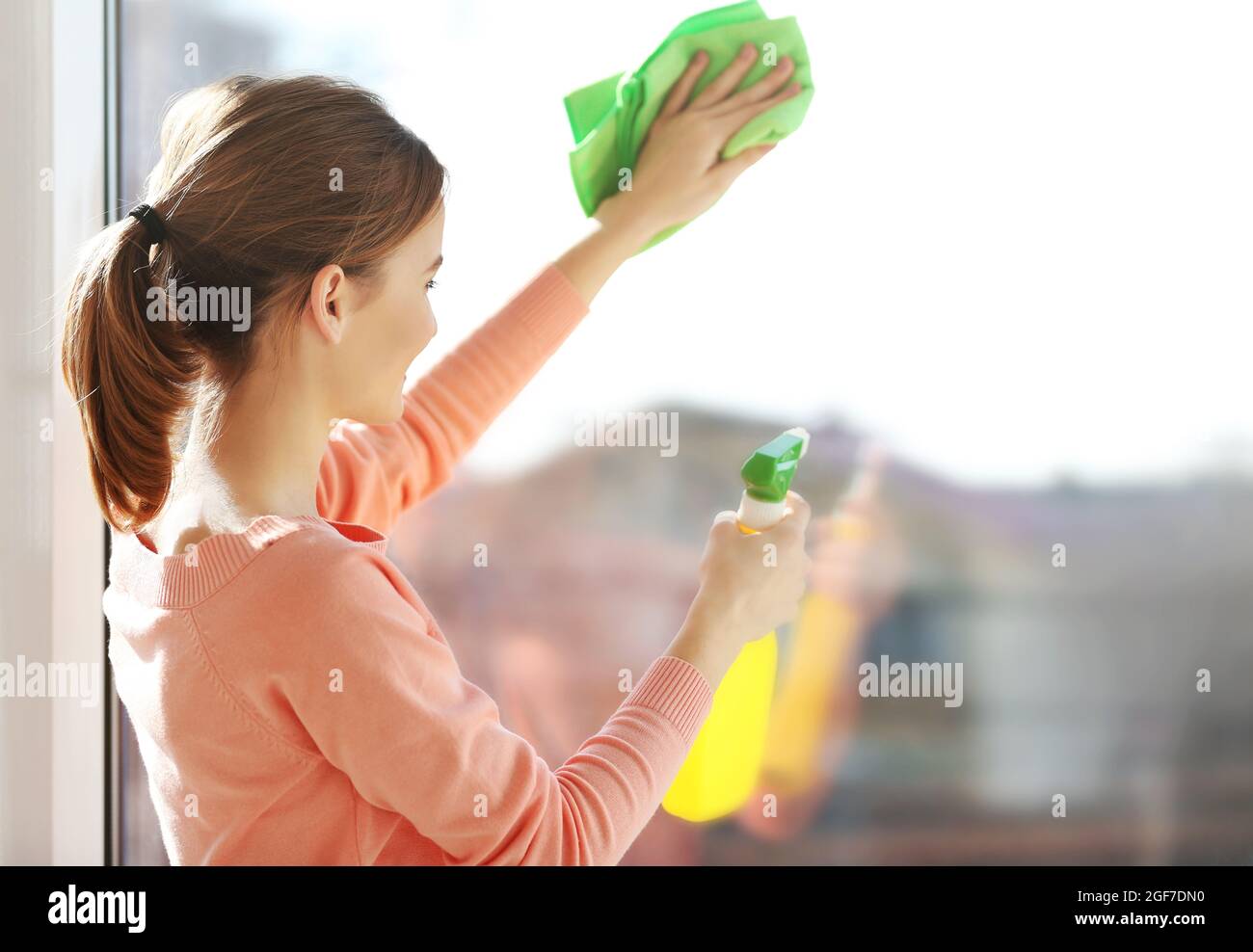 Cleaning concept. Young woman washing window, close up Stock Photo - Alamy