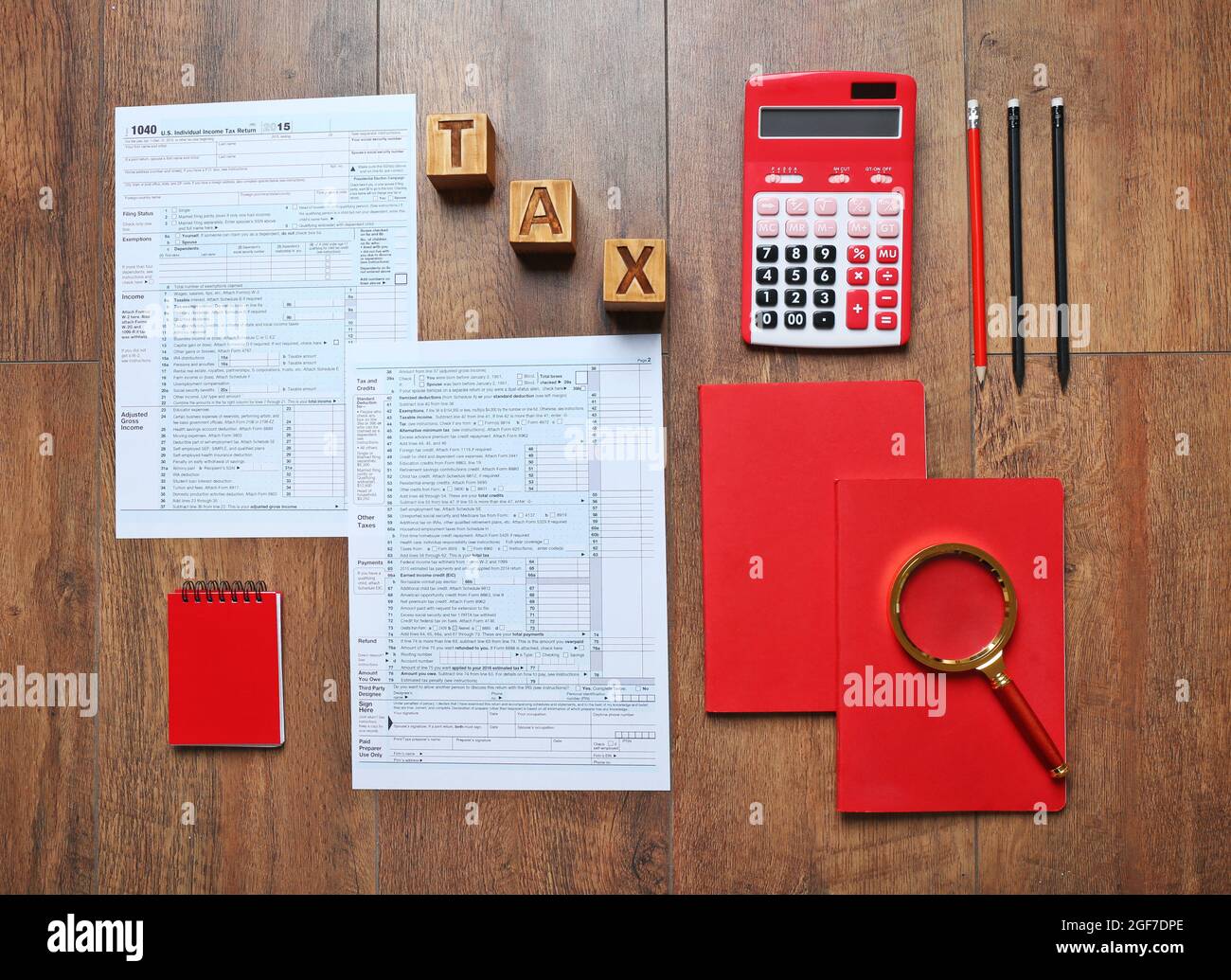 Individual income tax return, calculator and notebook on wooden ...