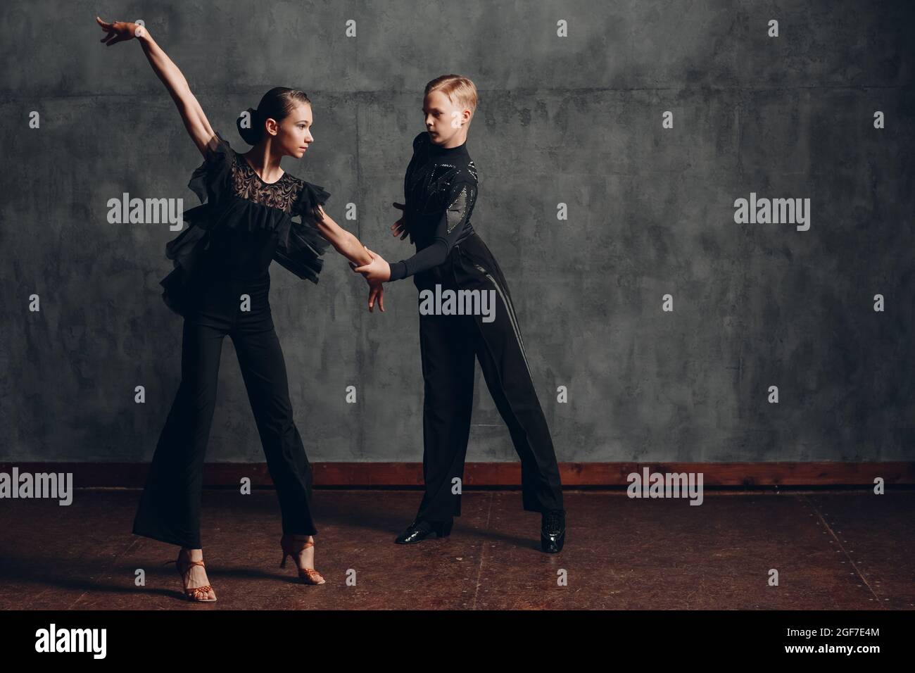 Young couple dancing in ballroom dance cha cha cha Stock Photo - Alamy