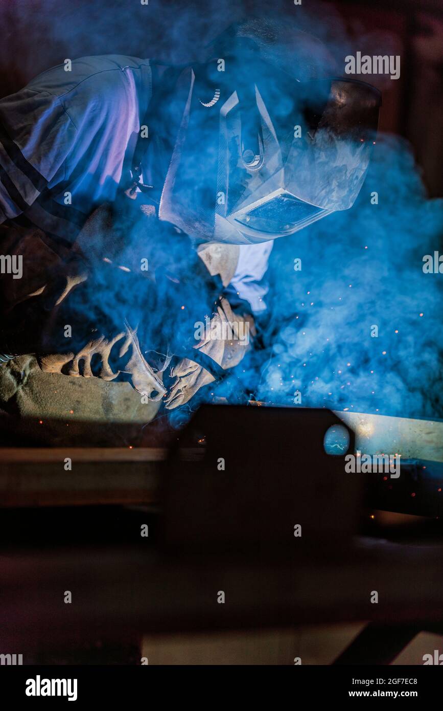 The welder works with a metal profile. Assembly of metal structures in ...