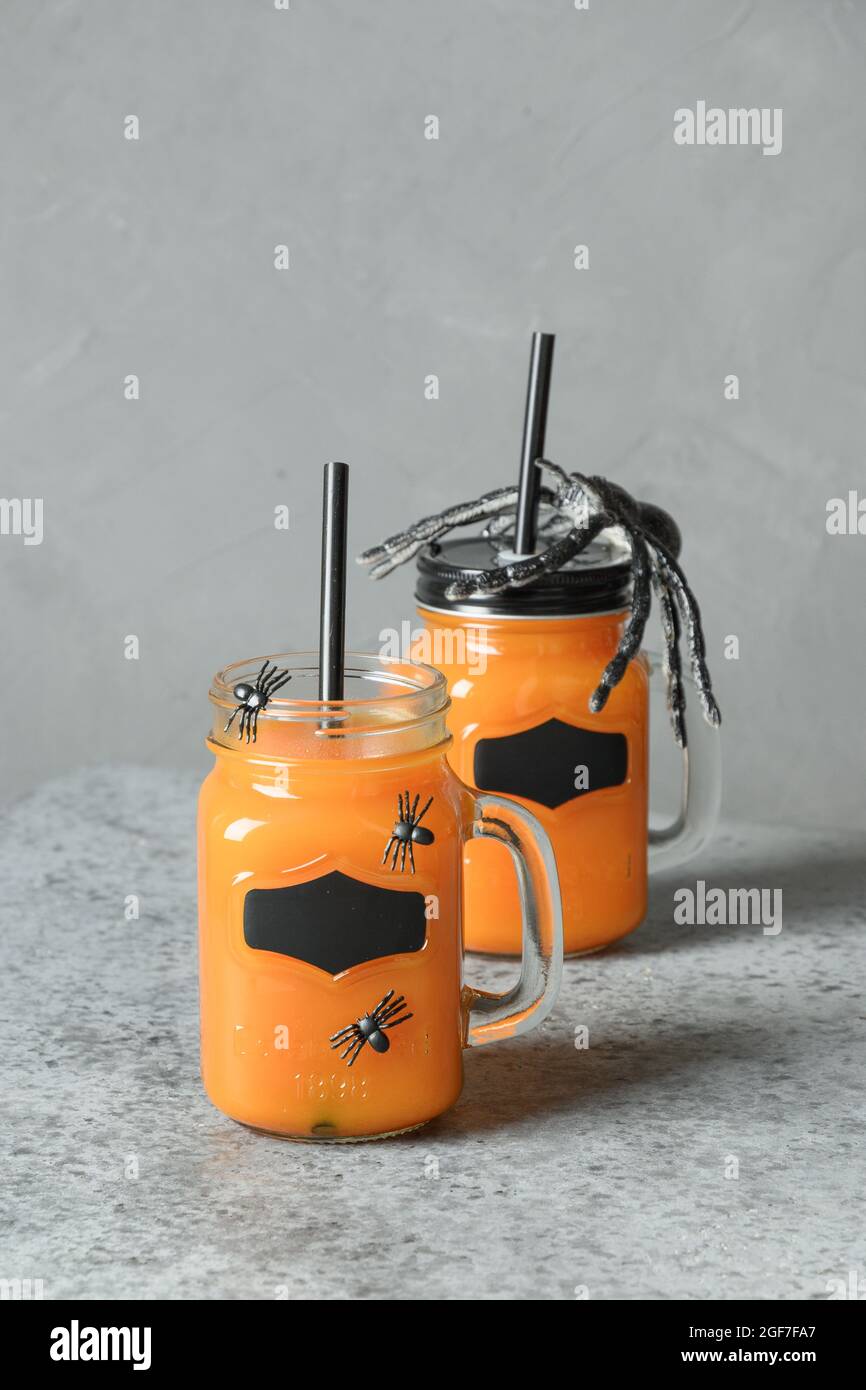 Halloween Cocktails with pumpkin juice, spice, garnish spiders for ...