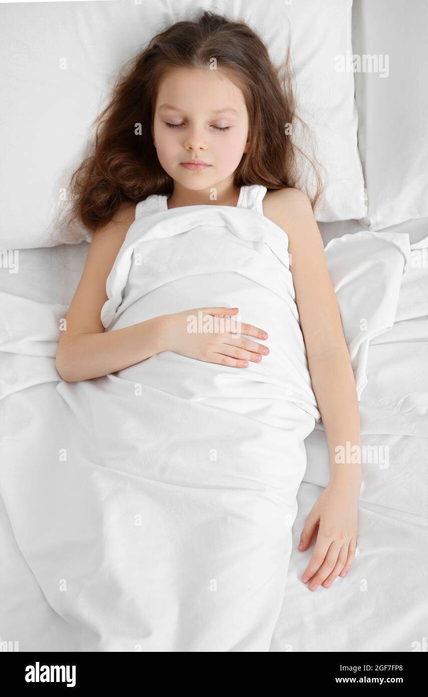 Little girl sleeping in bed Stock Photo - Alamy