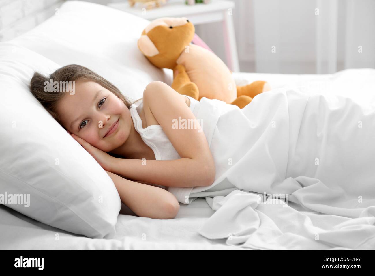 Little girl awake in bed Stock Photo - Alamy