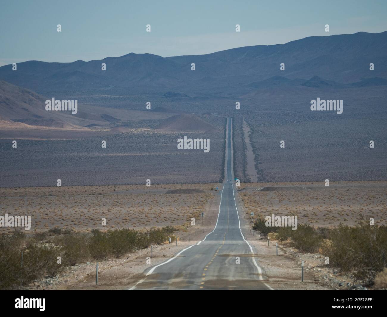 Lonely long road through desert landscape, Highway 190, Death Valley ...