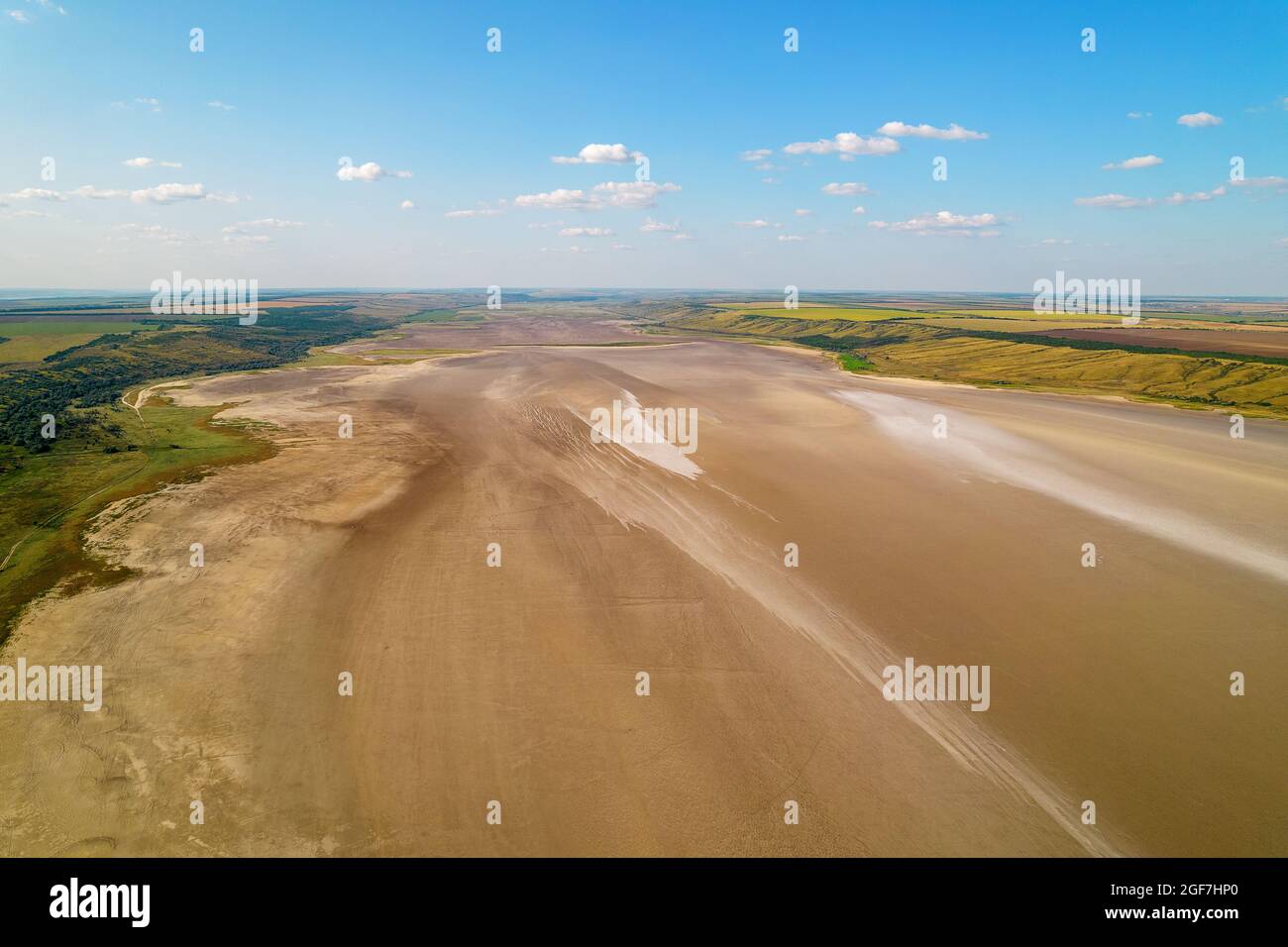 Amazing beauty of dried salty lake of light beige color surrounded by ...