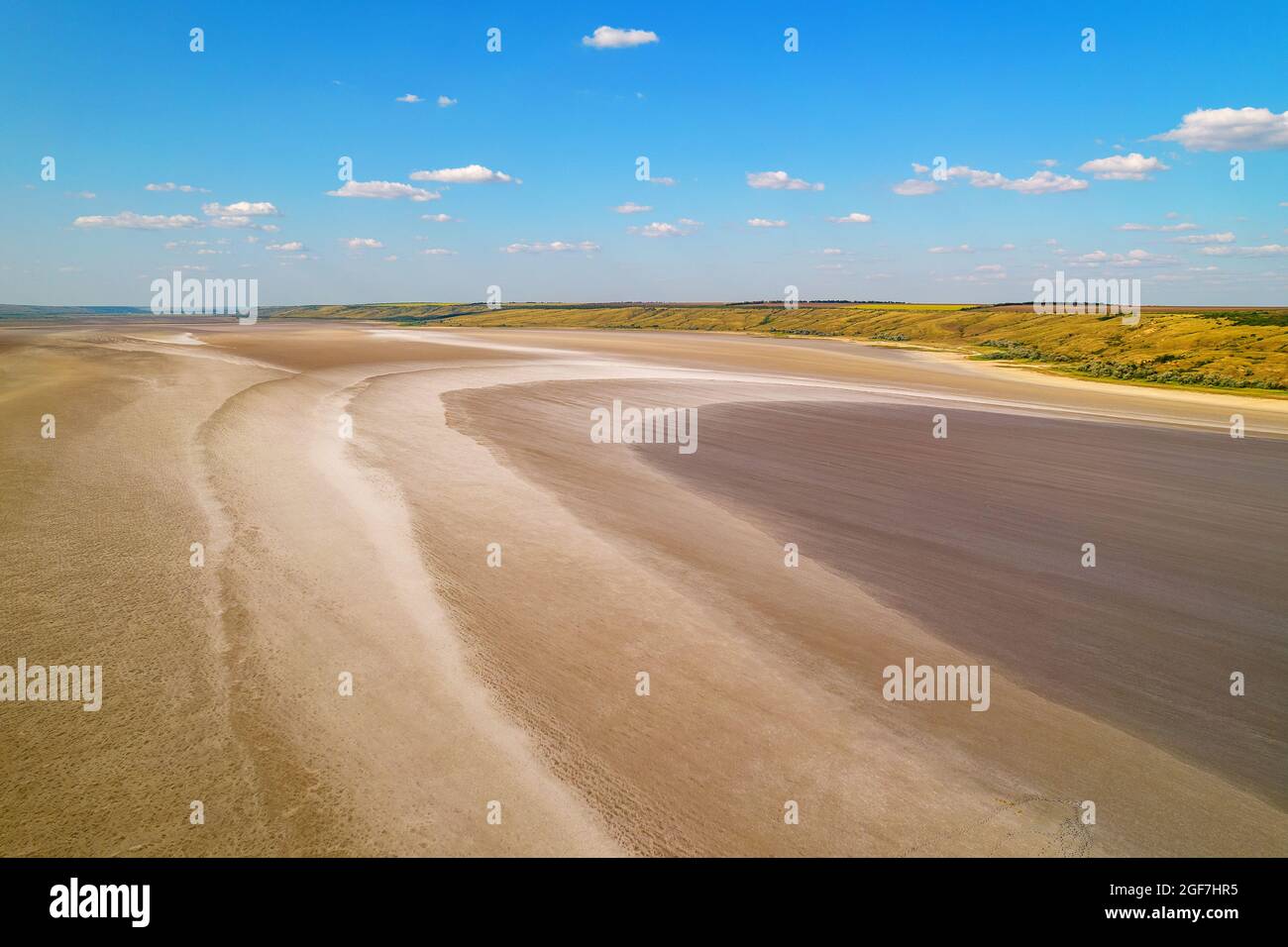 Amazing beauty of dried salty lake of light beige color surrounded by ...