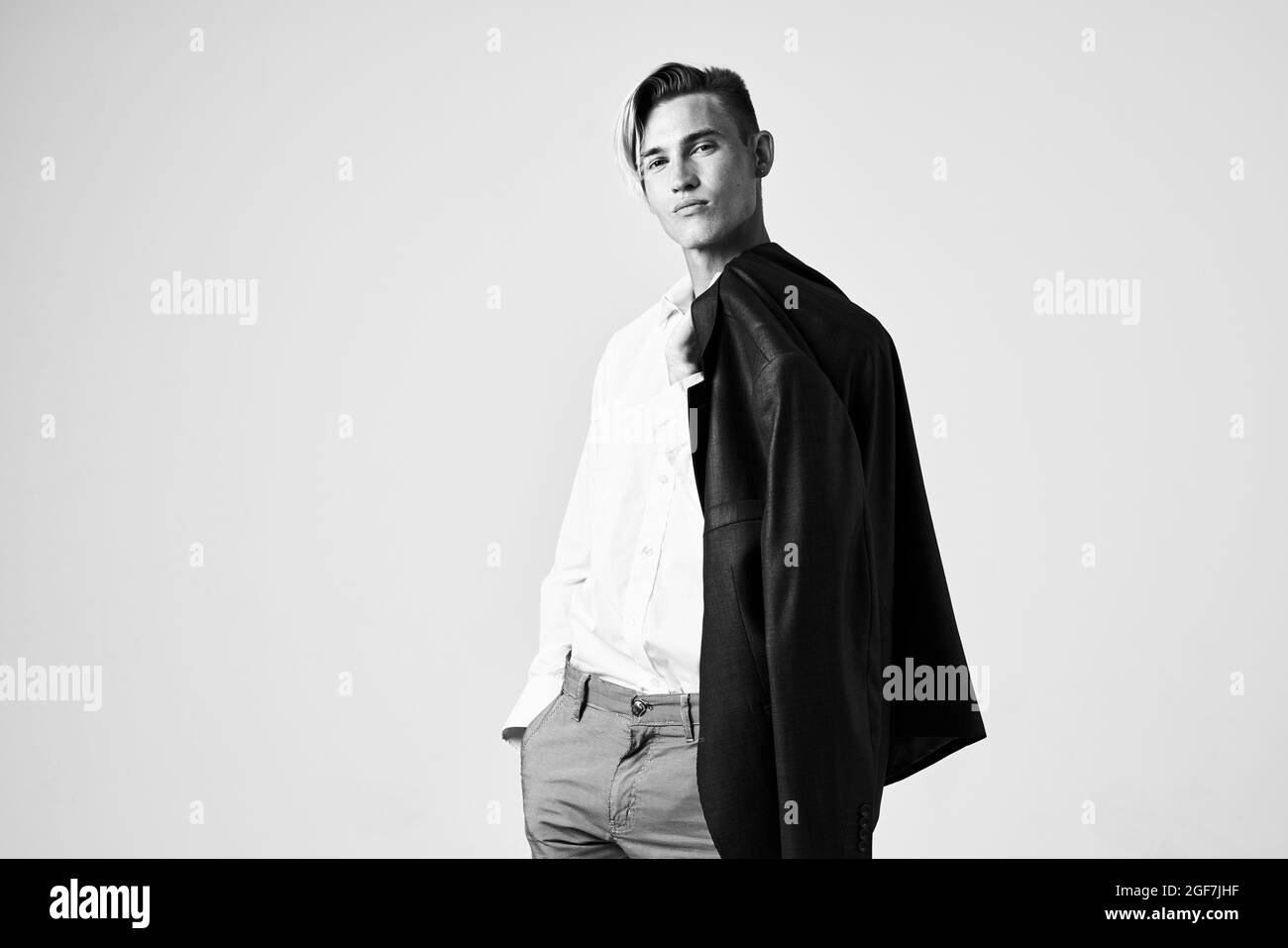 man with a jacket over his shoulders fashion studio lifestyle model ...