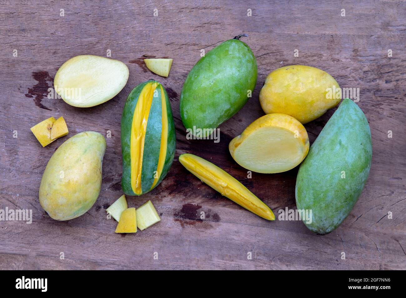 Variety of fresh mango on the old wooden table. fruits background ...