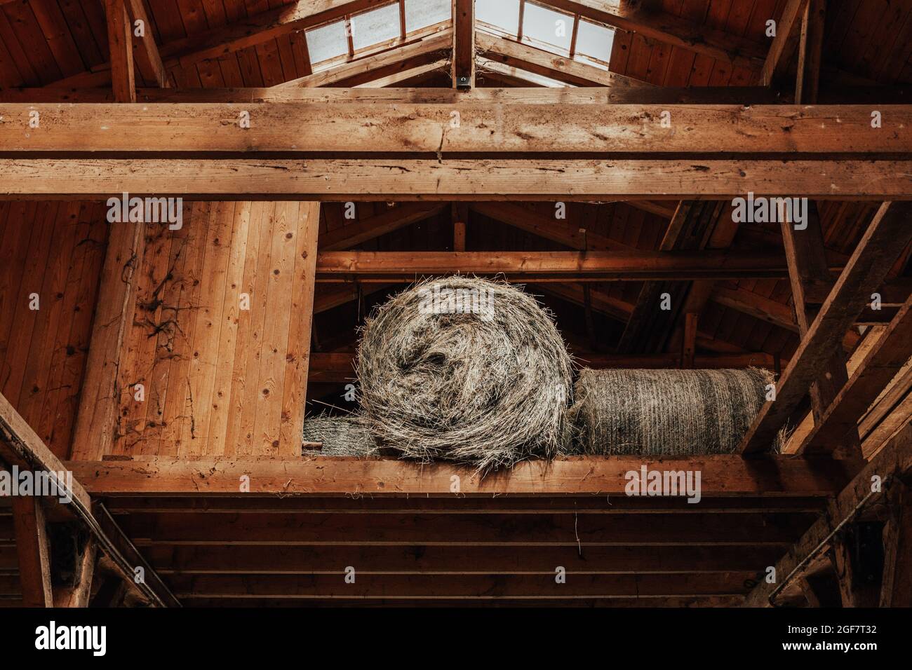 Bale of hay stored in wooden barn Stock Photo - Alamy