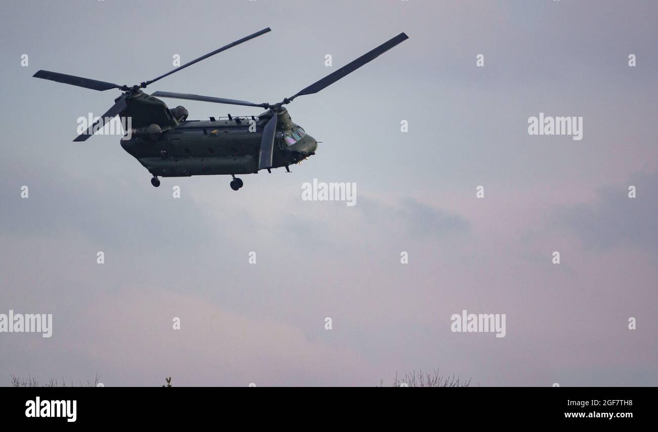 RAF Chinook tandem-rotor CH-47 helicopter flying fast and low in a ...